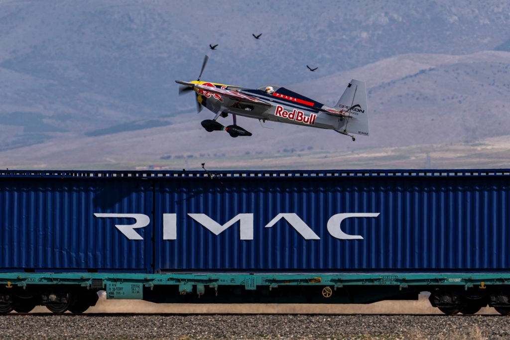 Red Bull pilot lands aircraft on moving train in world-first stunt