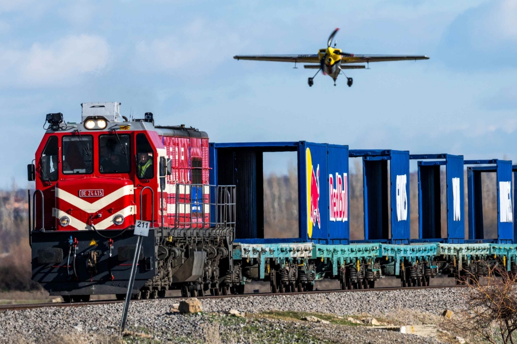 Red Bull pilot lands aircraft on moving train in world-first stunt