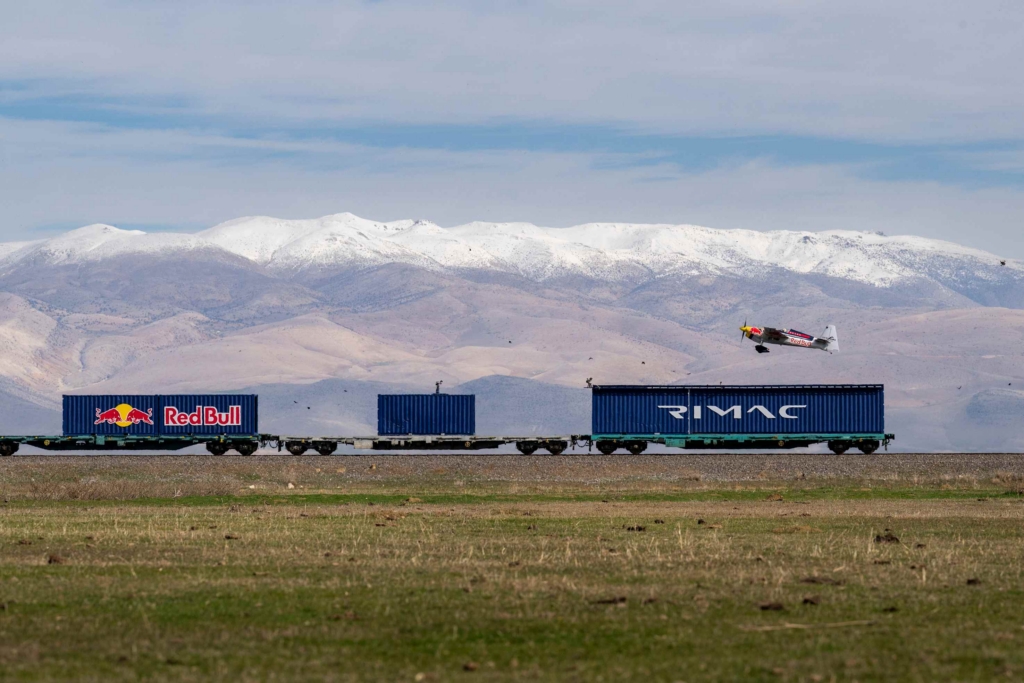Red Bull pilot lands aircraft on moving train in world-first stunt